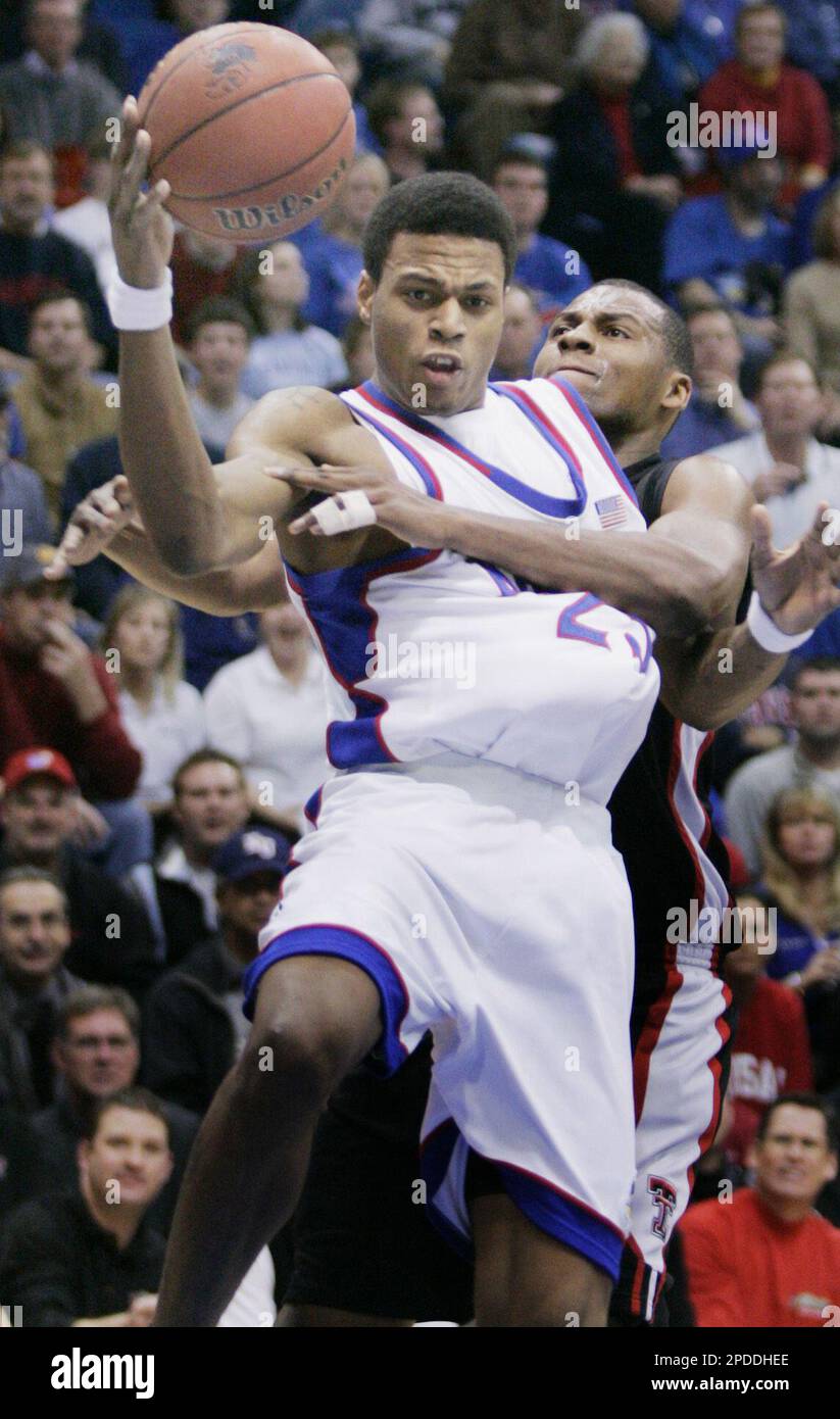 Kansas guard Brandon Rush, foreground, is fouled by Texas Tech forward ...