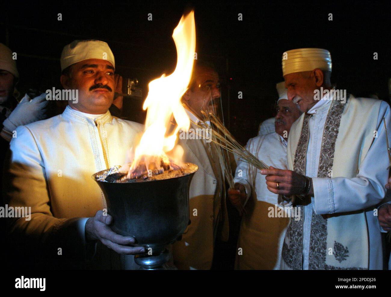 Iranian Zoroastrian priest Mehraban Firouzgari, right, talks with ...