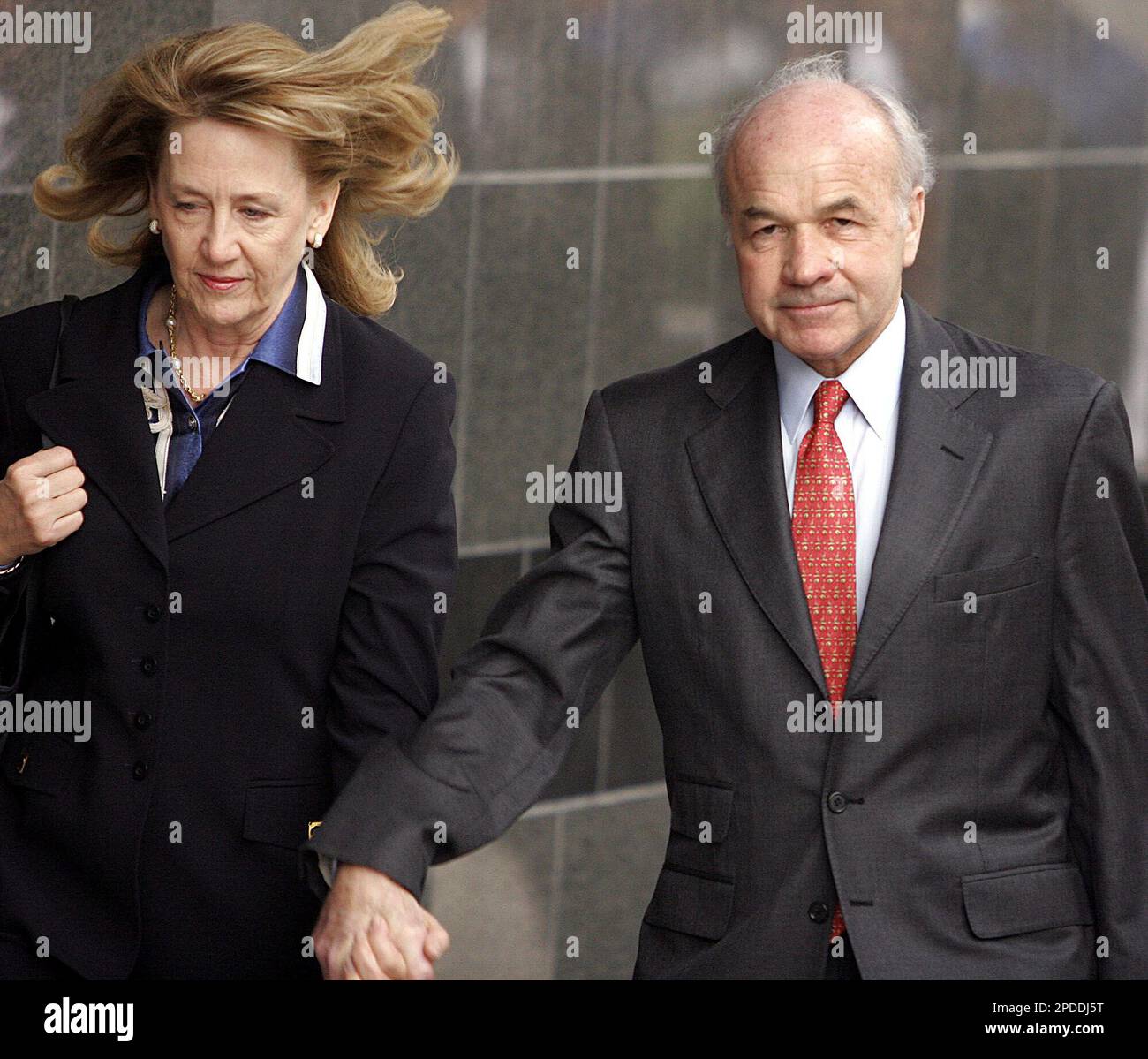 Walking hand in hand with his wife Linda, former Enron founder Ken Lay ...