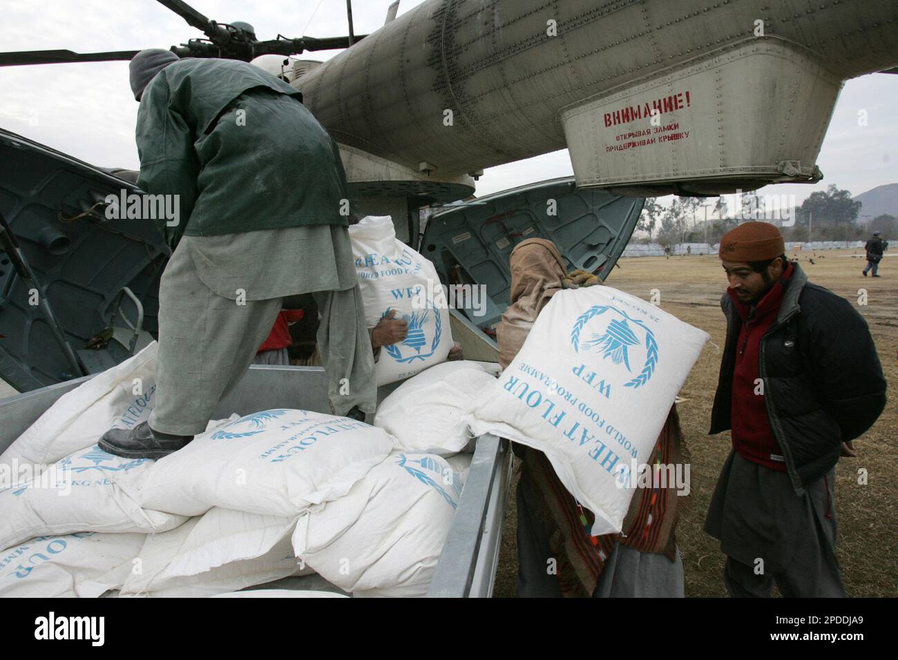 Pakistani volunteers load food supplies provided by the World Food ...