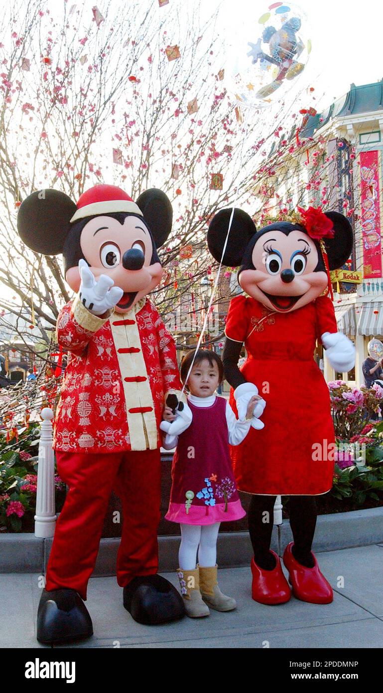 Mickey Mouse and Minnie Mouse dressed in Chinese traditional new year ...