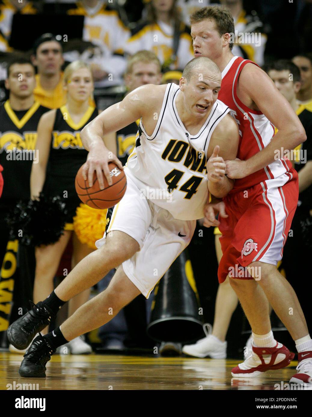 Iowa's Greg Brunner, left, looks to drive around Ohio State's Matt ...