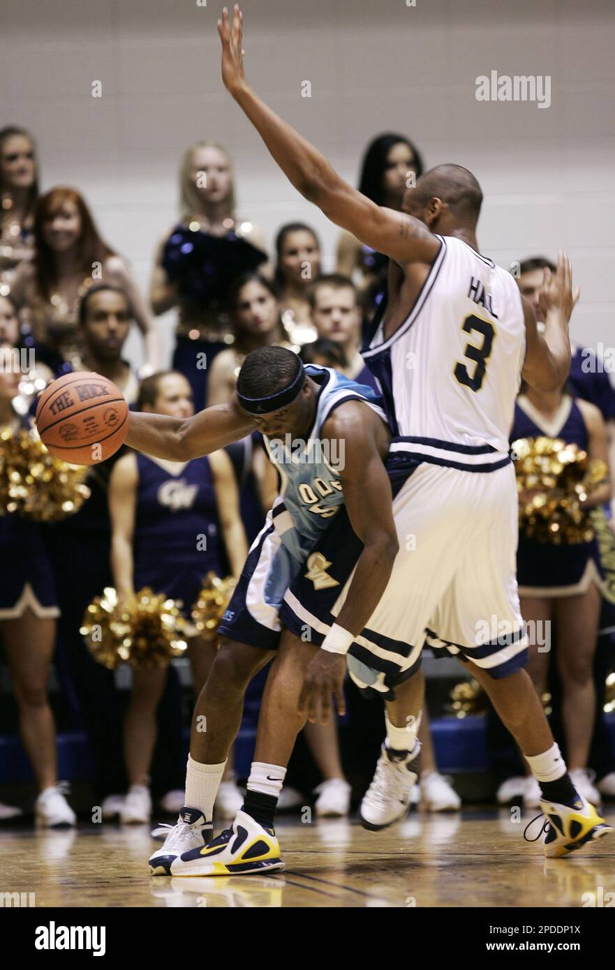 Rhode Island's Dawan Robinson pushes around George Washington's Mike ...