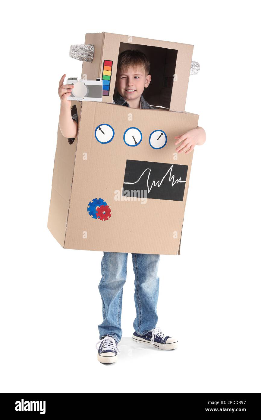Little boy in cardboard robot costume taking selfie on white background ...