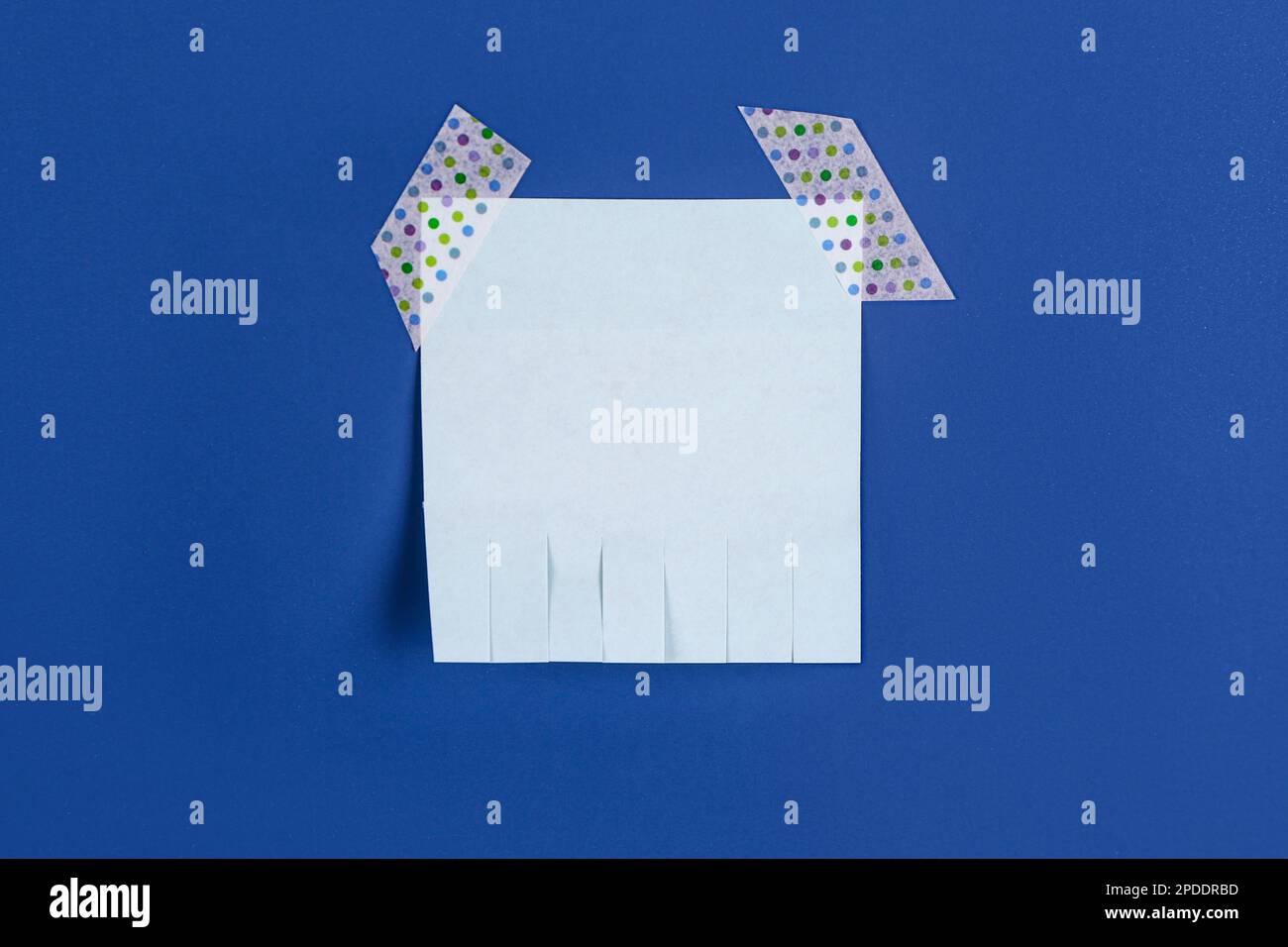Blank paper tear-off ad on blue background Stock Photo - Alamy