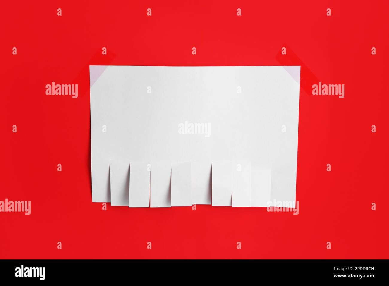 Blank paper tear-off ad on red background Stock Photo - Alamy