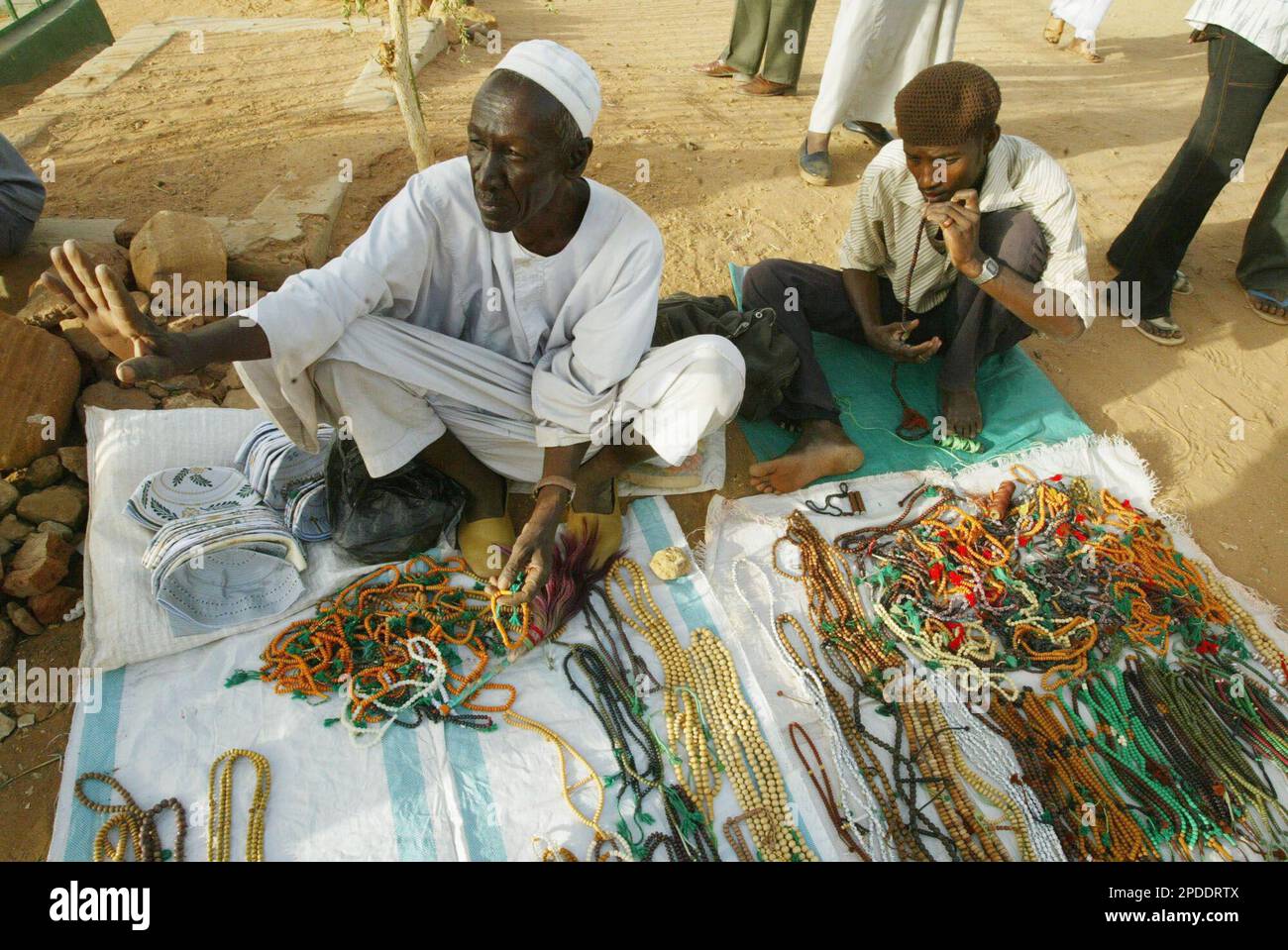 A Sudanese display religious praying beads to sell at a religious ...