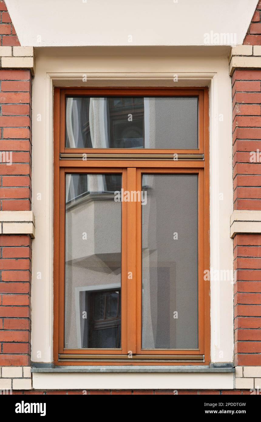 View of brick building with wooden window Stock Photo - Alamy