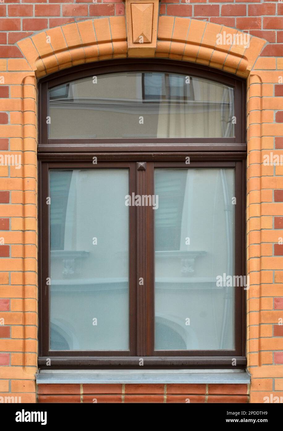 View of brick building with wooden window Stock Photo - Alamy