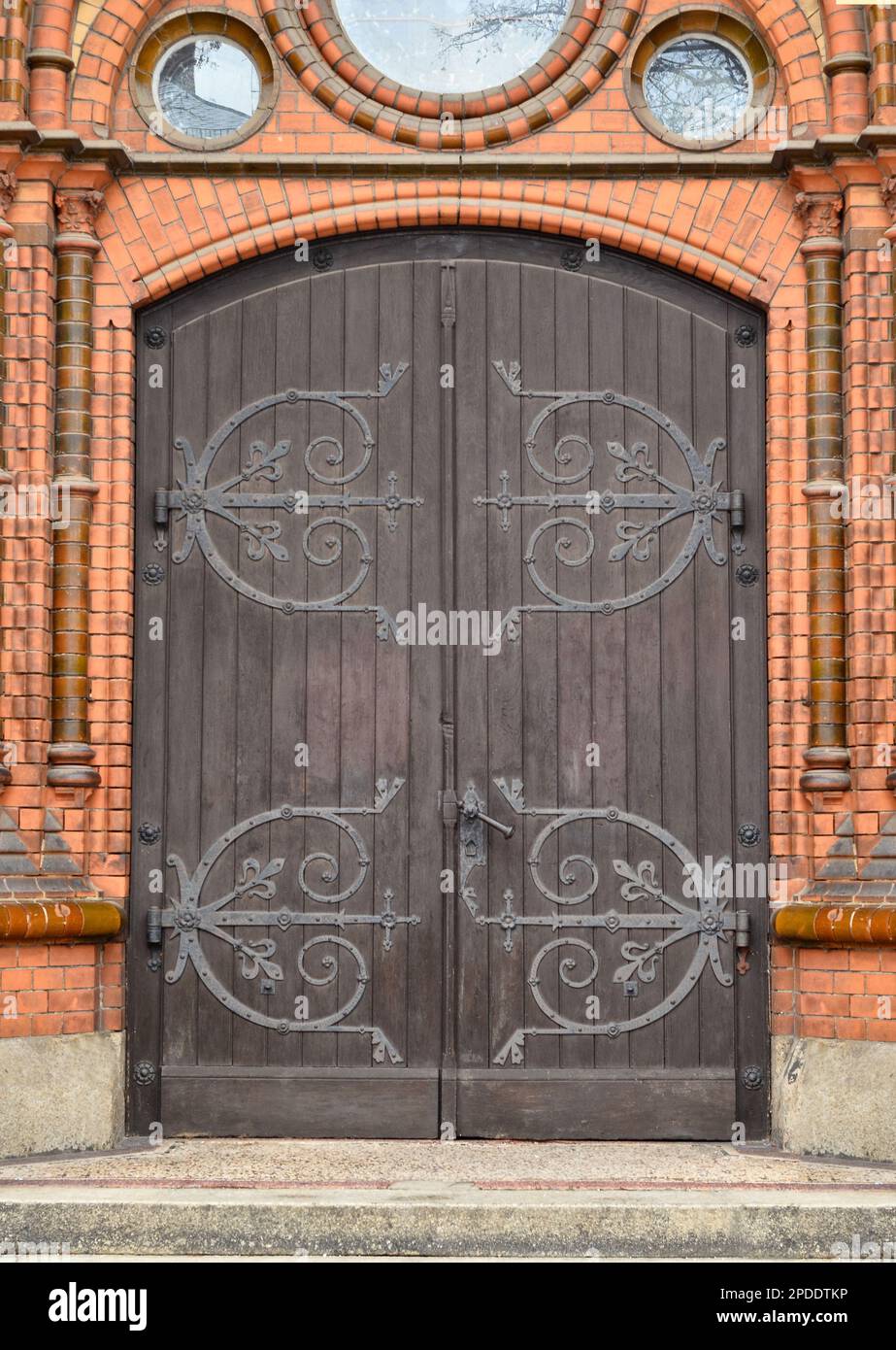 View of brick building with wooden door Stock Photo - Alamy
