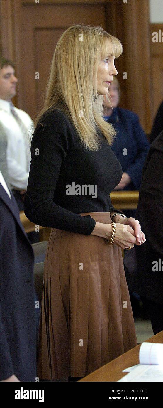 Defendant Barbara Asher stands as the judge enters the courtroom in ...