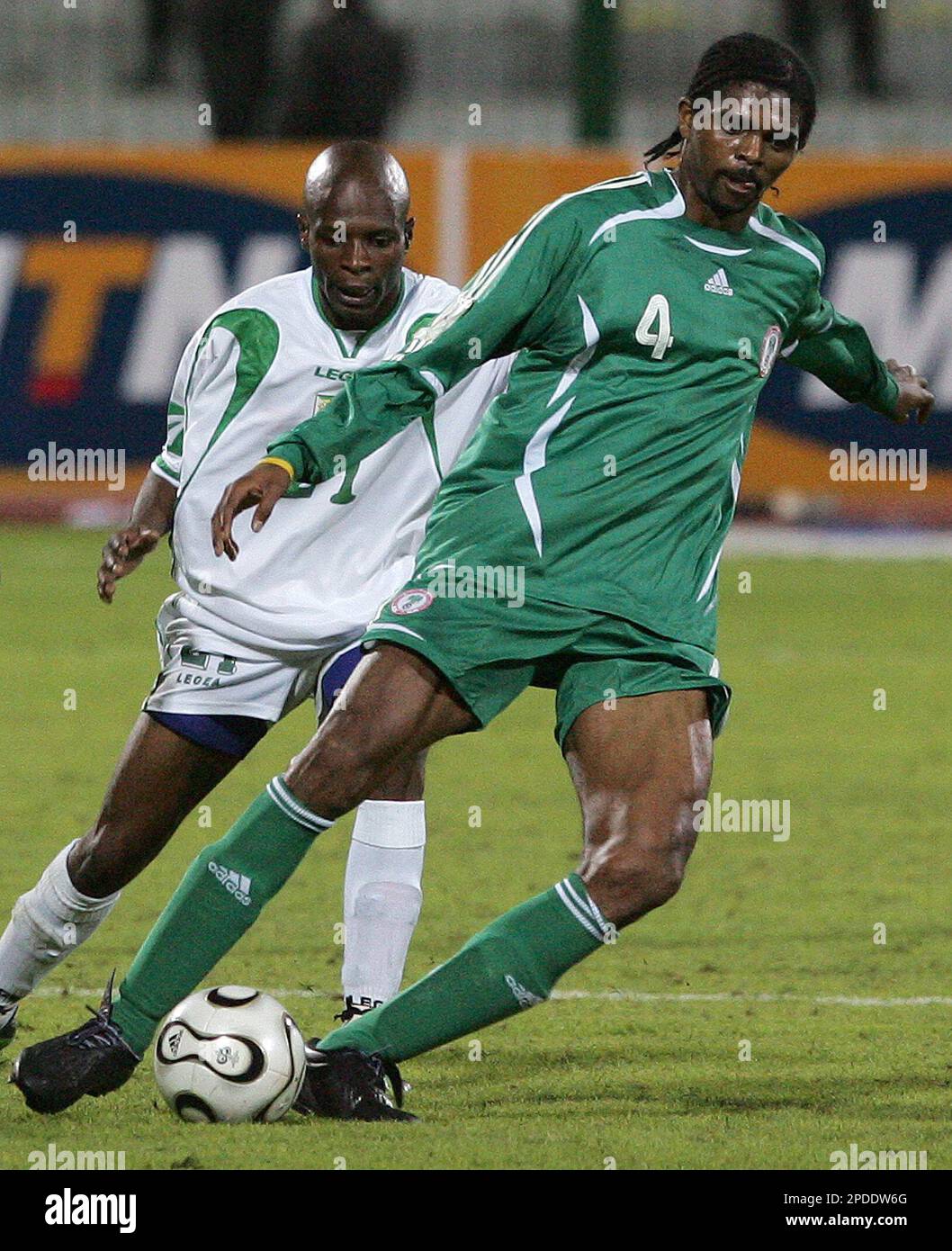 Nigeria's Nwankwo Kanu, front, controls the ball past Zimbabwe's James ...