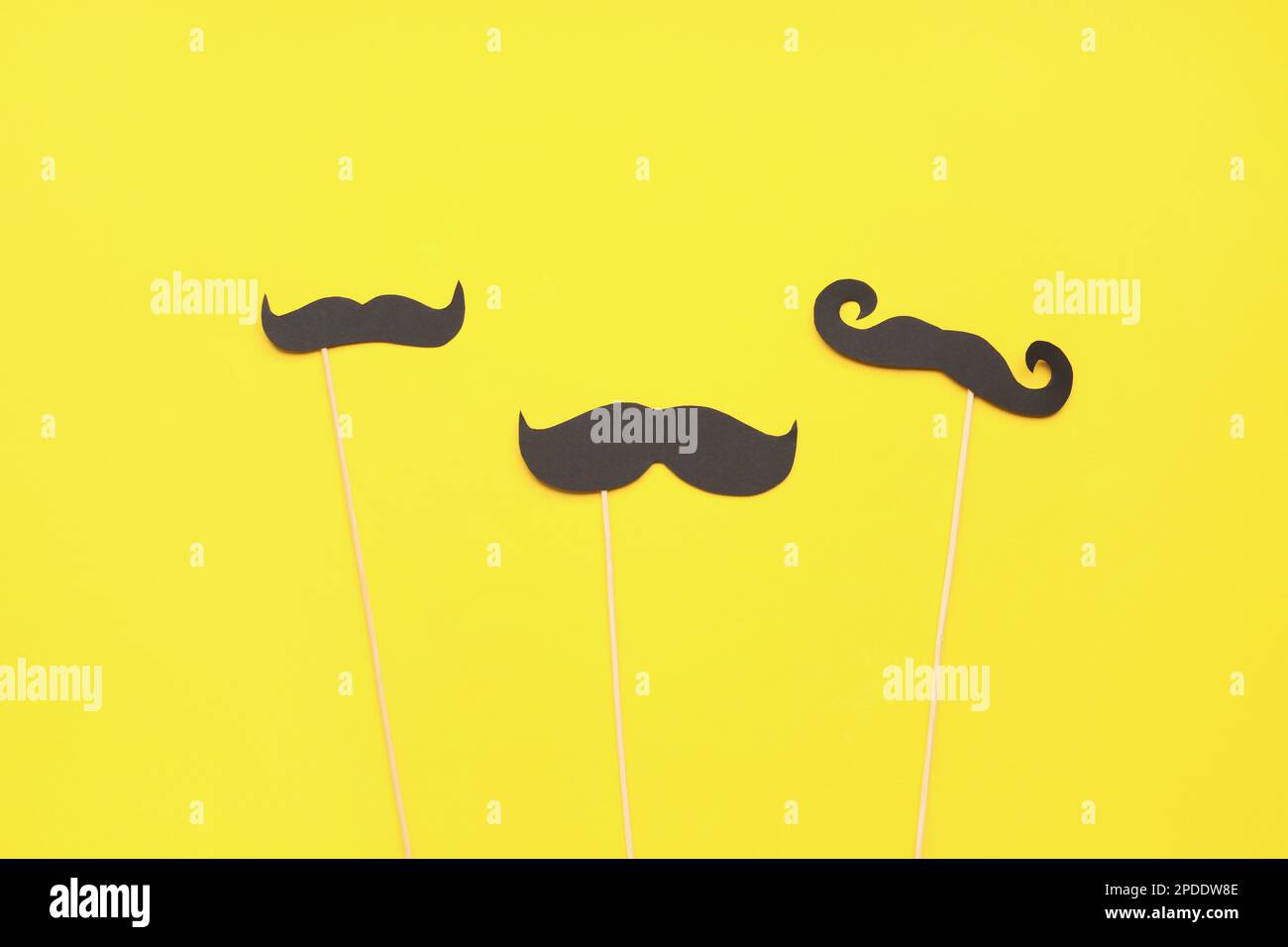 Set of paper mustaches on yellow background Stock Photo - Alamy