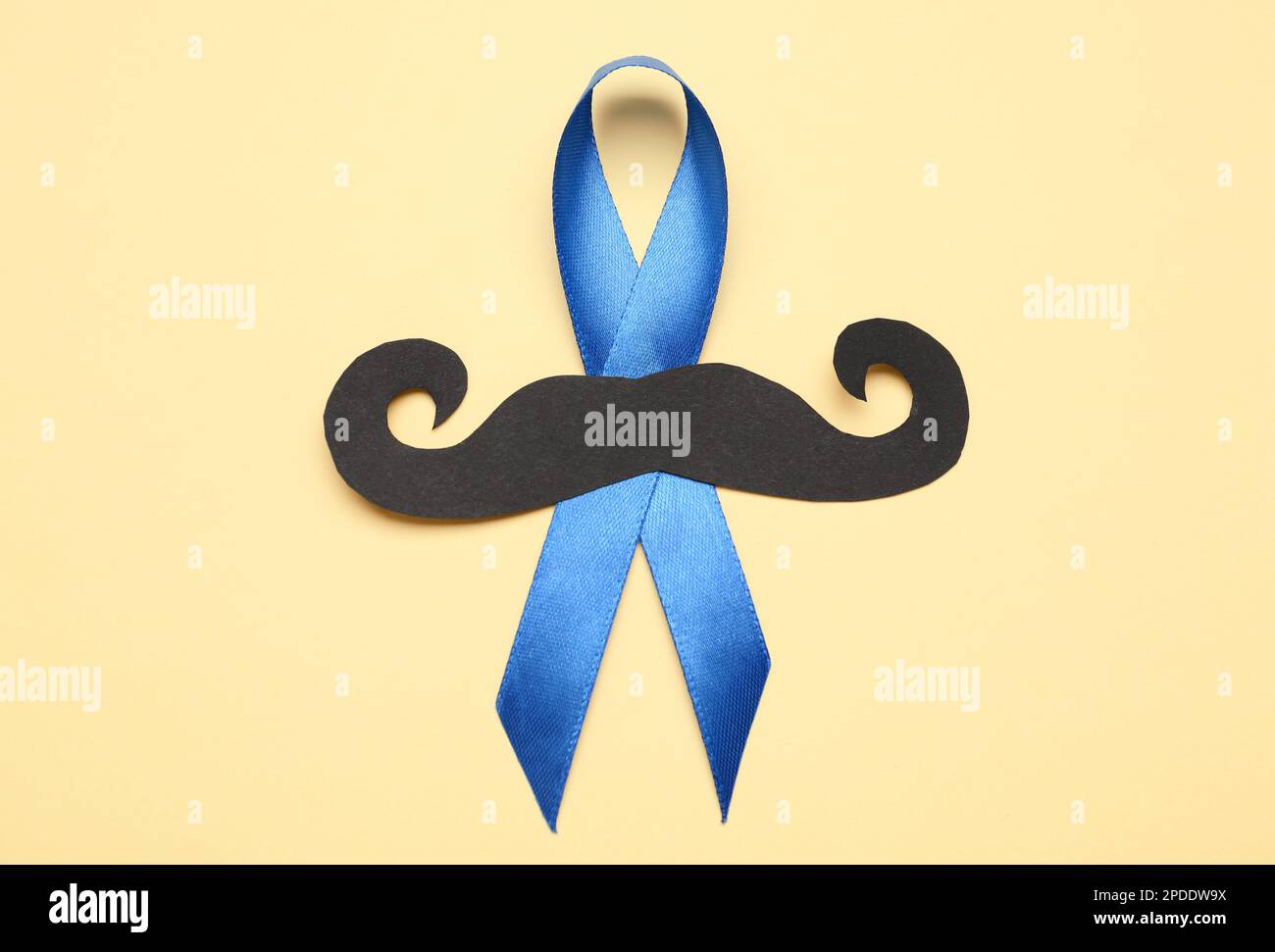 Blue awareness ribbon with black paper mustache on color background ...