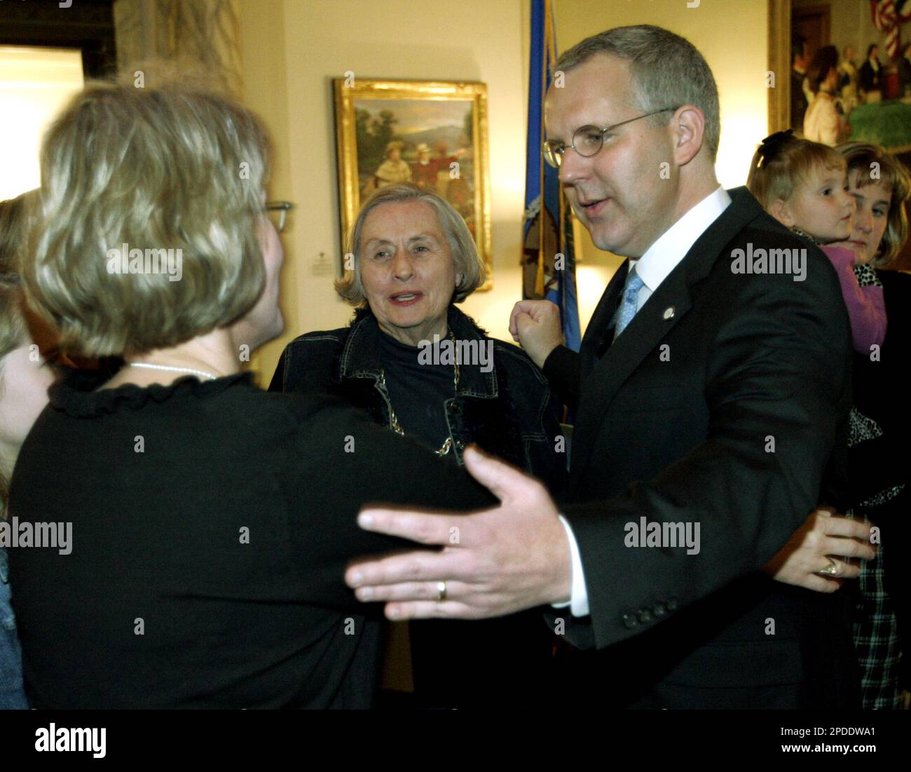 Oklahoma Gov. Brad Henry, right, greets Robin Wenk, left, and Robbie ...