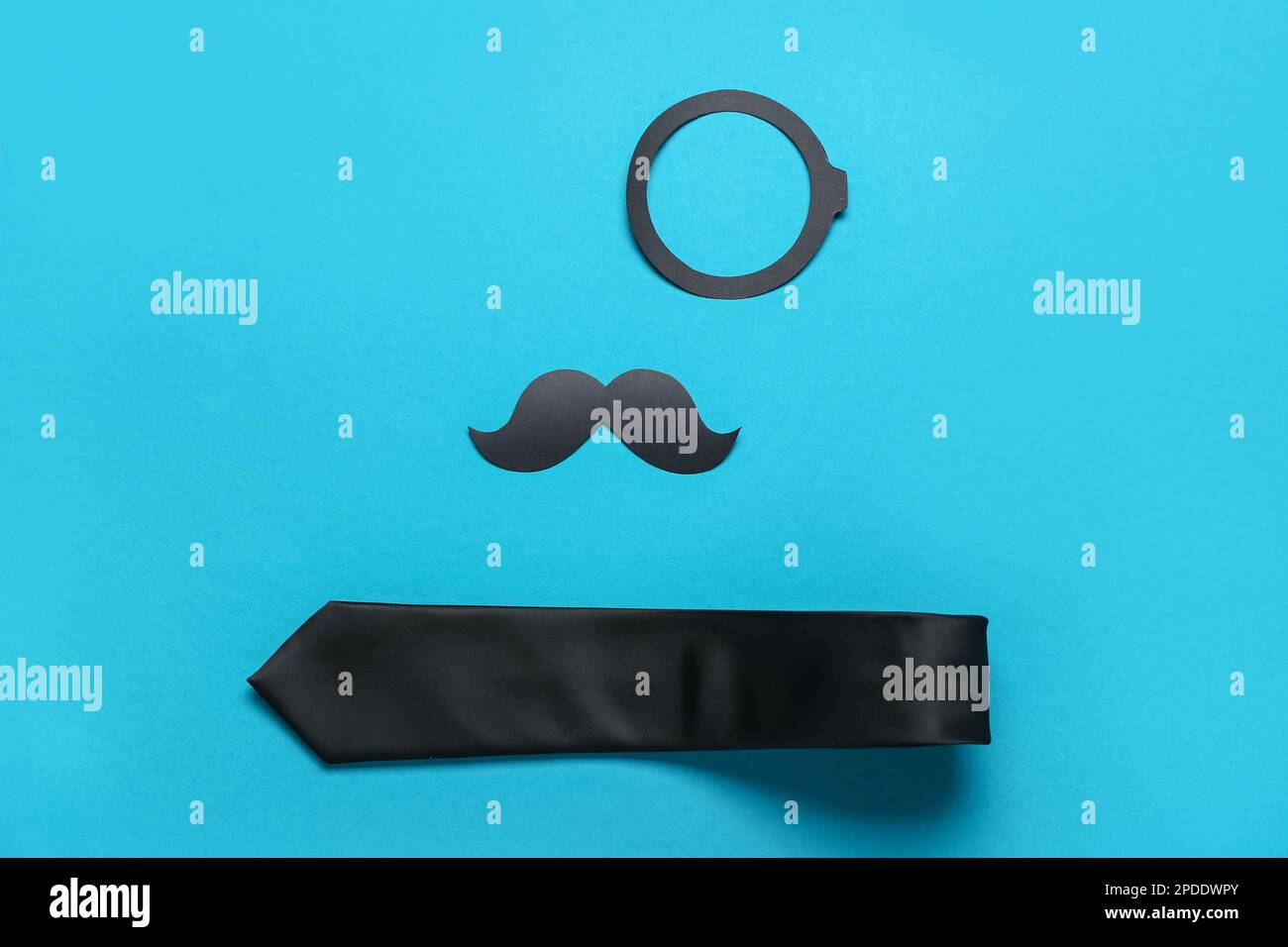 Composition with paper monocle, mustache and tie on color background ...