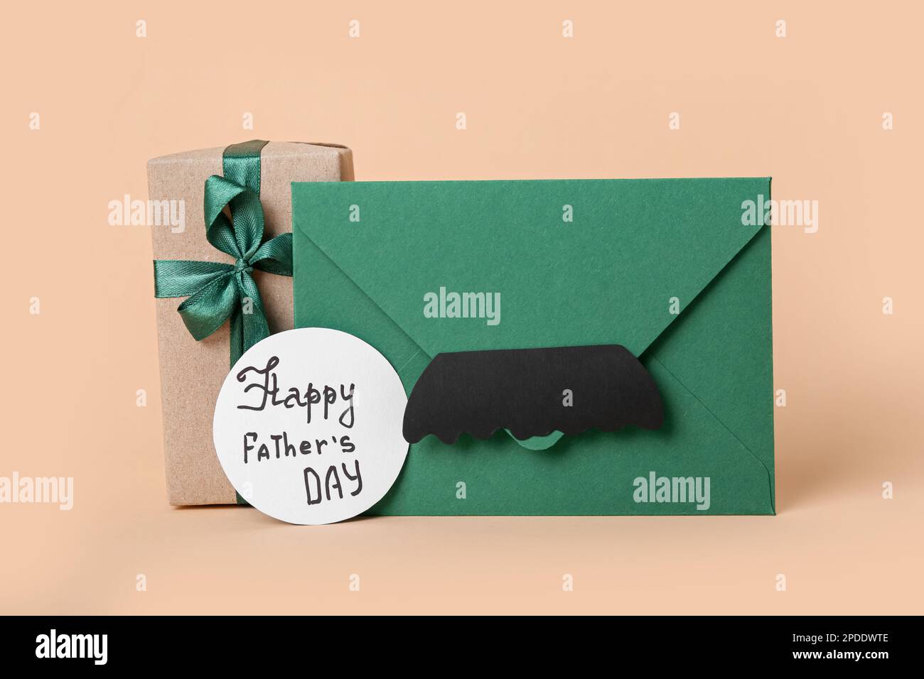 Envelope with paper mustache and gift for Father's Day celebration on ...