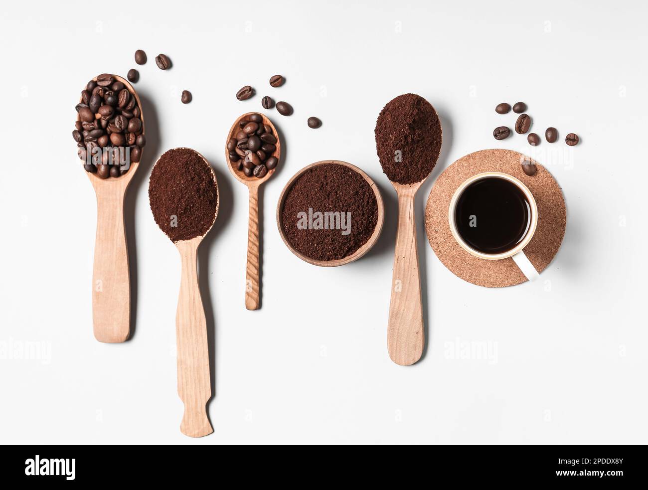 Spoons of coffee powder, beans and cup on white background Stock Photo ...
