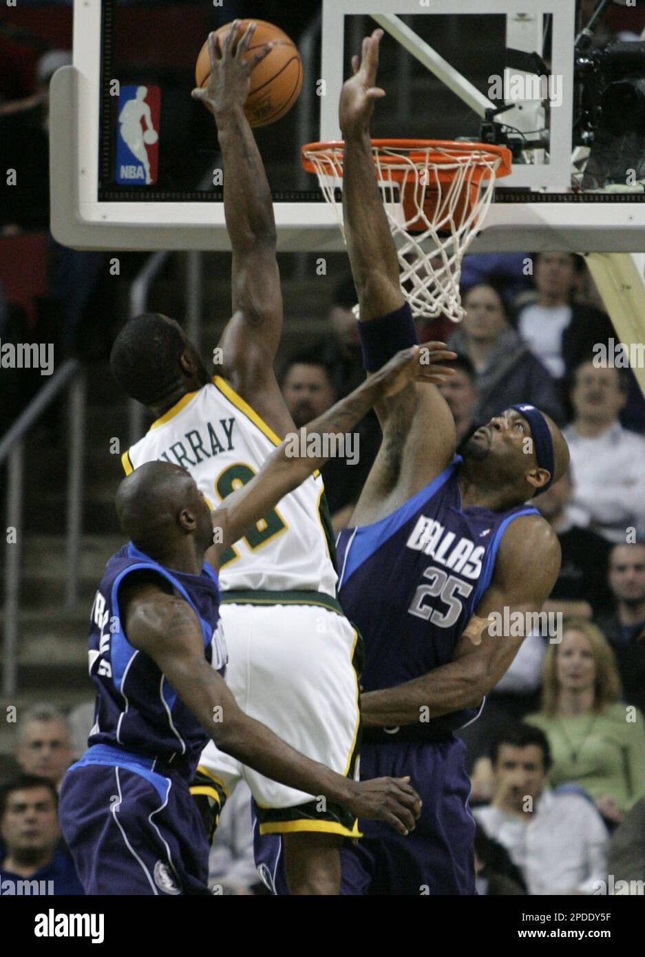 Seattle SuperSonics Ronald Murray, center, goes in for a dunk as Dallas ...