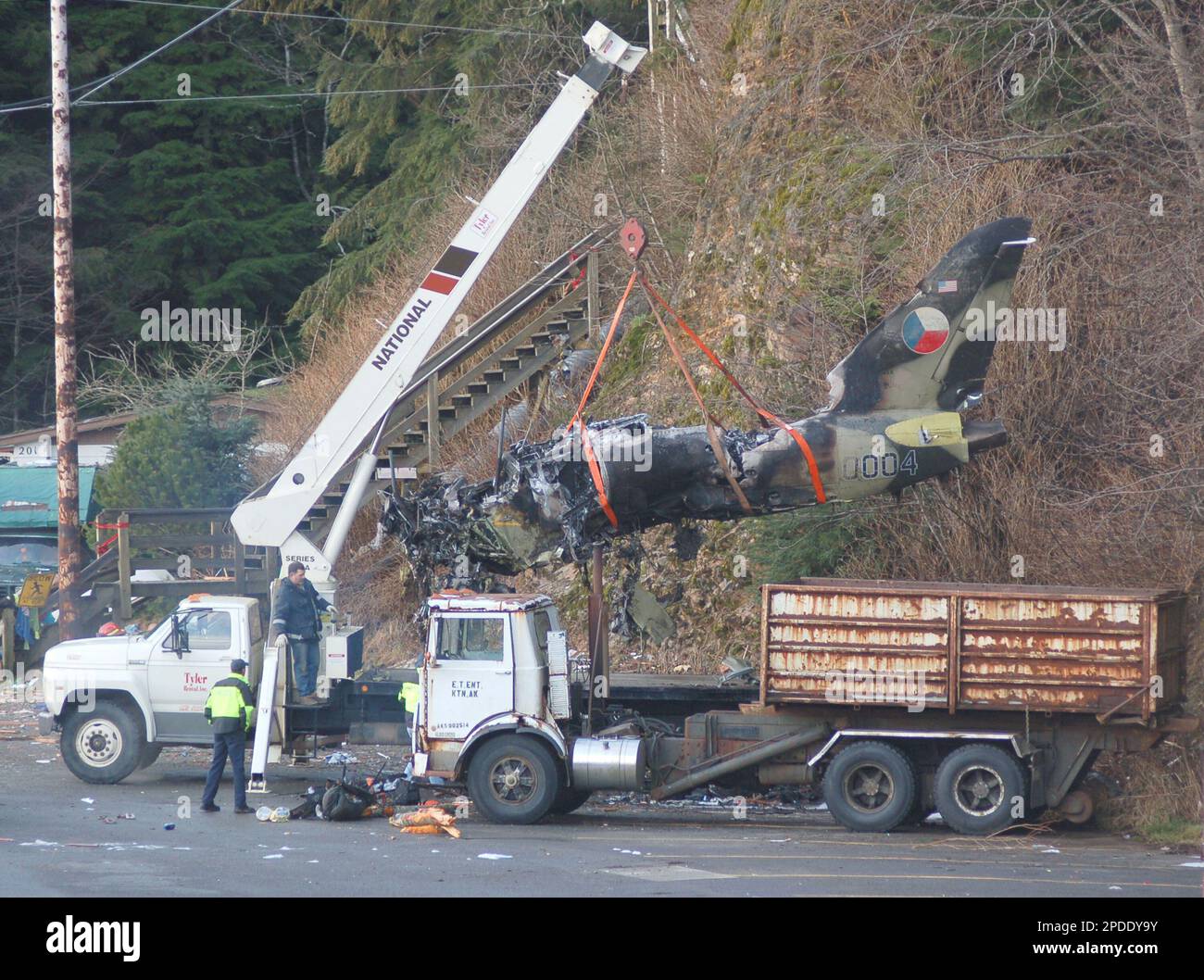 Ketchikan Fire Dept personnel lower the burned out fuselage of a Czech ...