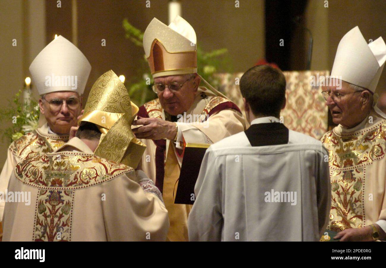 Principle Ordaining Bishop His Eminence Adam Cardinal Maida places a ...