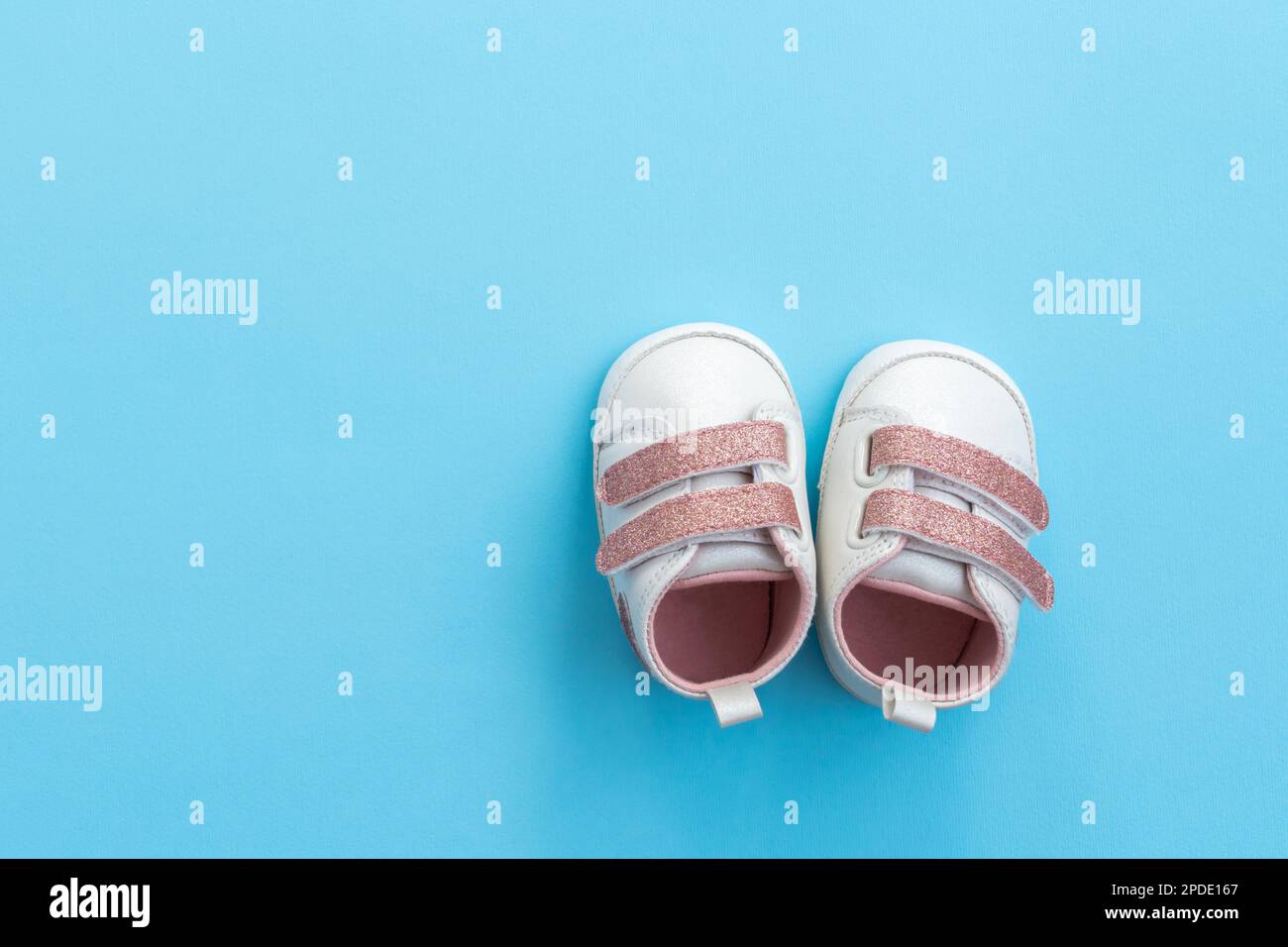 Baby shoes on paper background with copy space. Baby clothes concept ...