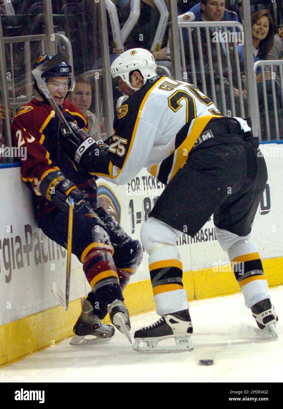 Boston Bruins defenseman Hal Gill (25) checks Atlanta Thrashers center ...
