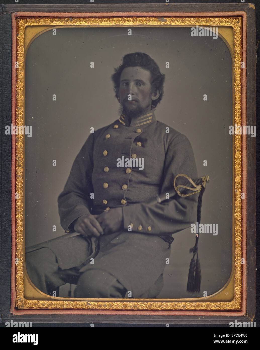 Unidentified soldier in Confederate uniform with cavalry sword and knot ...