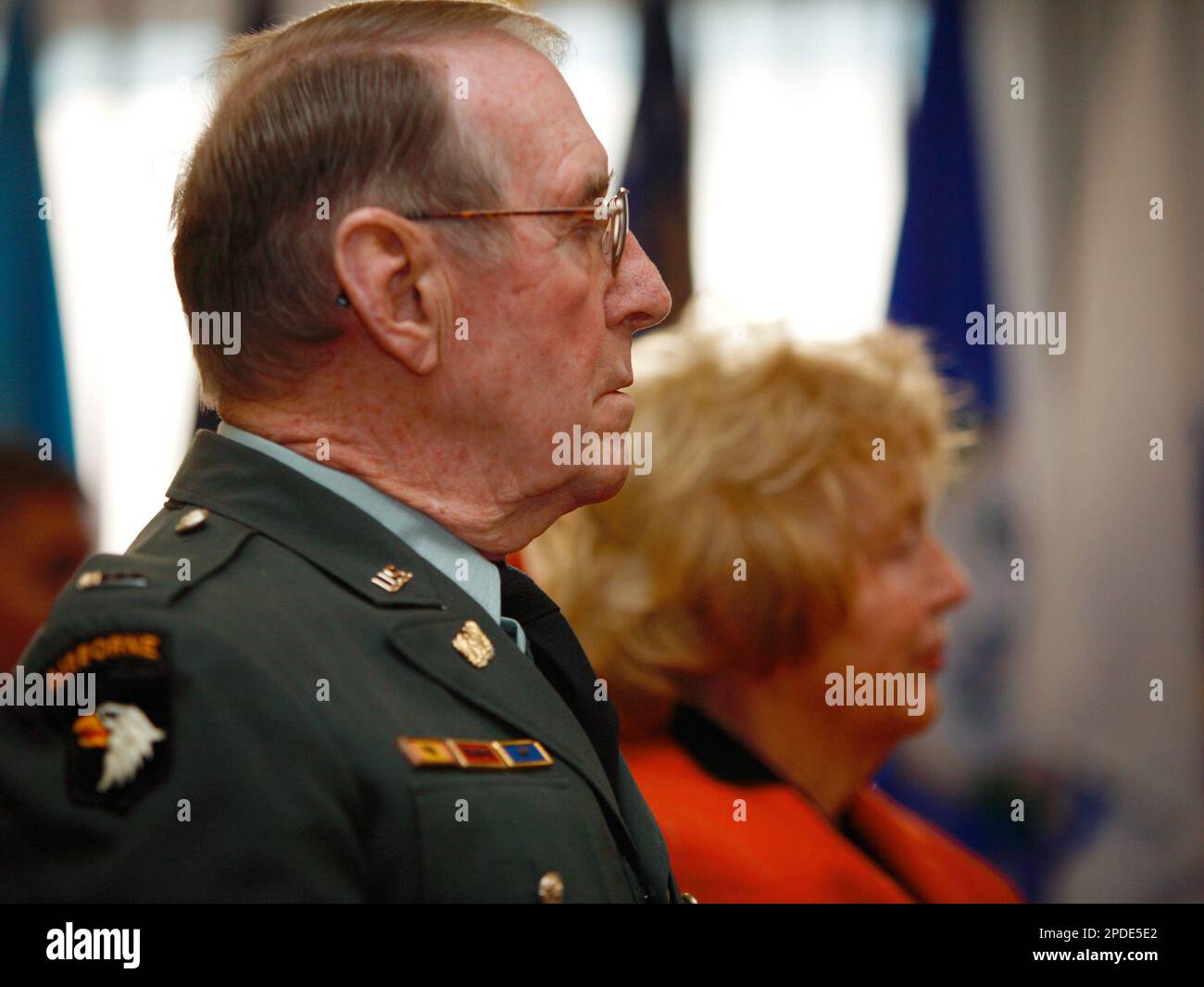 Chief Warrant Officer (ret.) Walter Schramm listens to an introduction ...