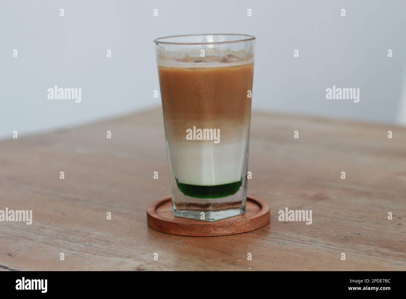 a glass of pandan coffee latte served cold on the table Stock Photo - Alamy