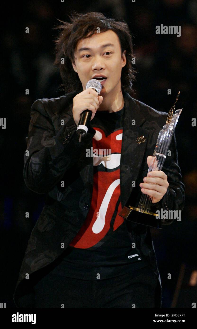 Hong kong singer Eason Chan holds the trophy after award the best Top ...