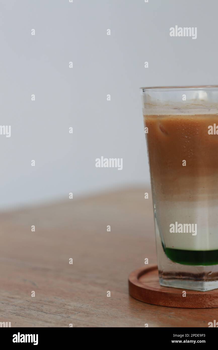 a glass of pandan coffee latte served cold on the table Stock Photo - Alamy