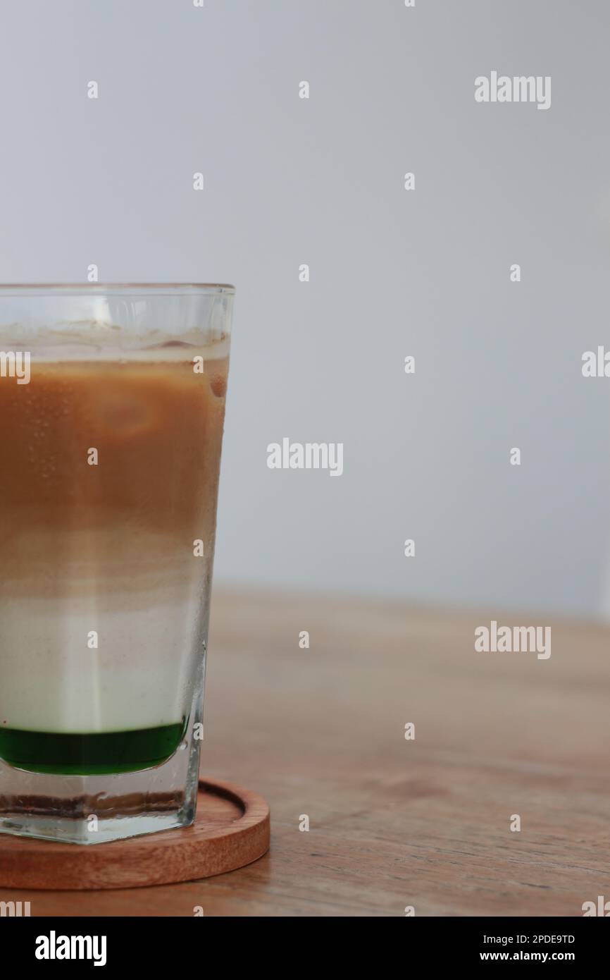 a glass of pandan coffee latte served cold on the table Stock Photo - Alamy