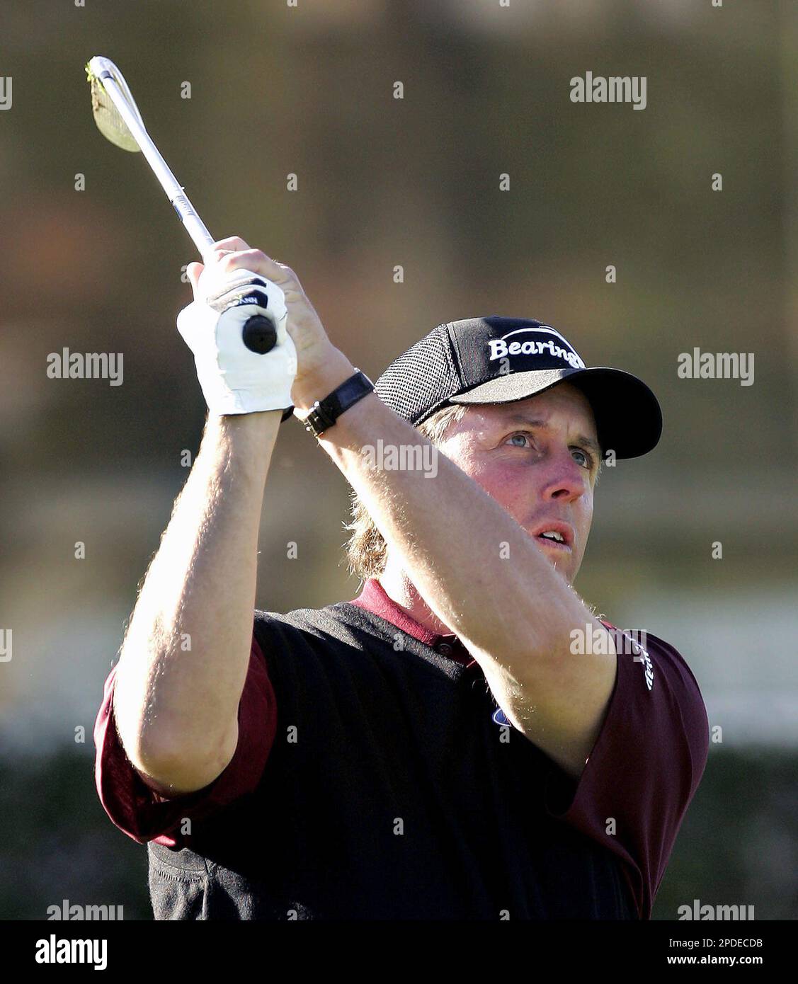PGA golfer Phil Mickelson watches his tee shot into the 12th hole at ...