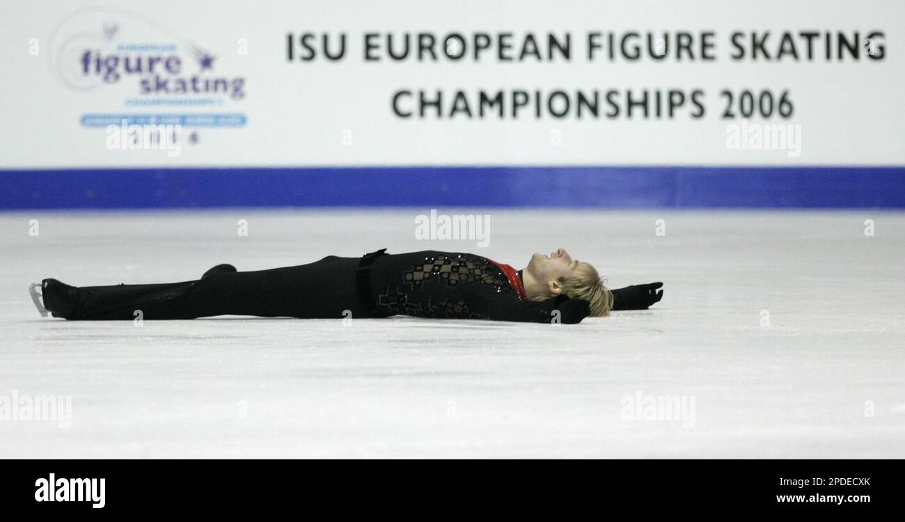 Evgeni Plushenko, representing Russia, lays on the ice after performing ...