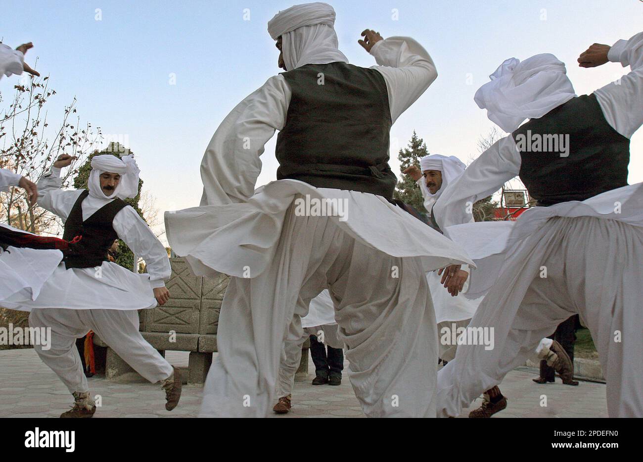 Veiled traditionally dressed Iranian men, perform a traditional dance ...