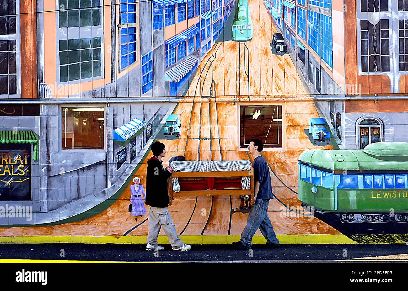 Adam Judkins, left, and Scott Poli move a couch Thursday, Jan. 19, 2006 ...