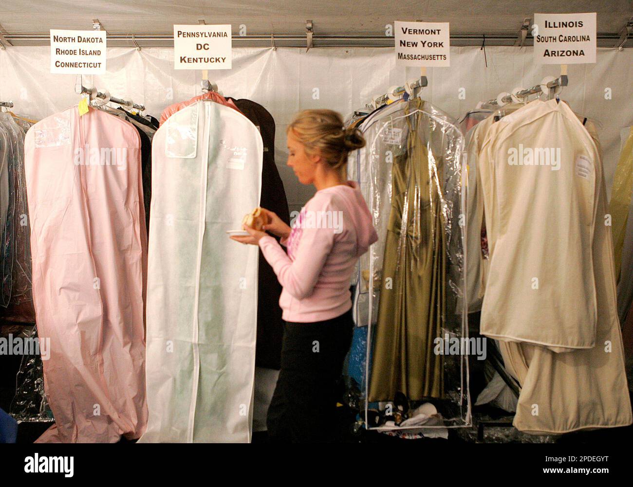 Crystal Wosik, Miss Nevada, walks past dresses hanging on the racks in ...