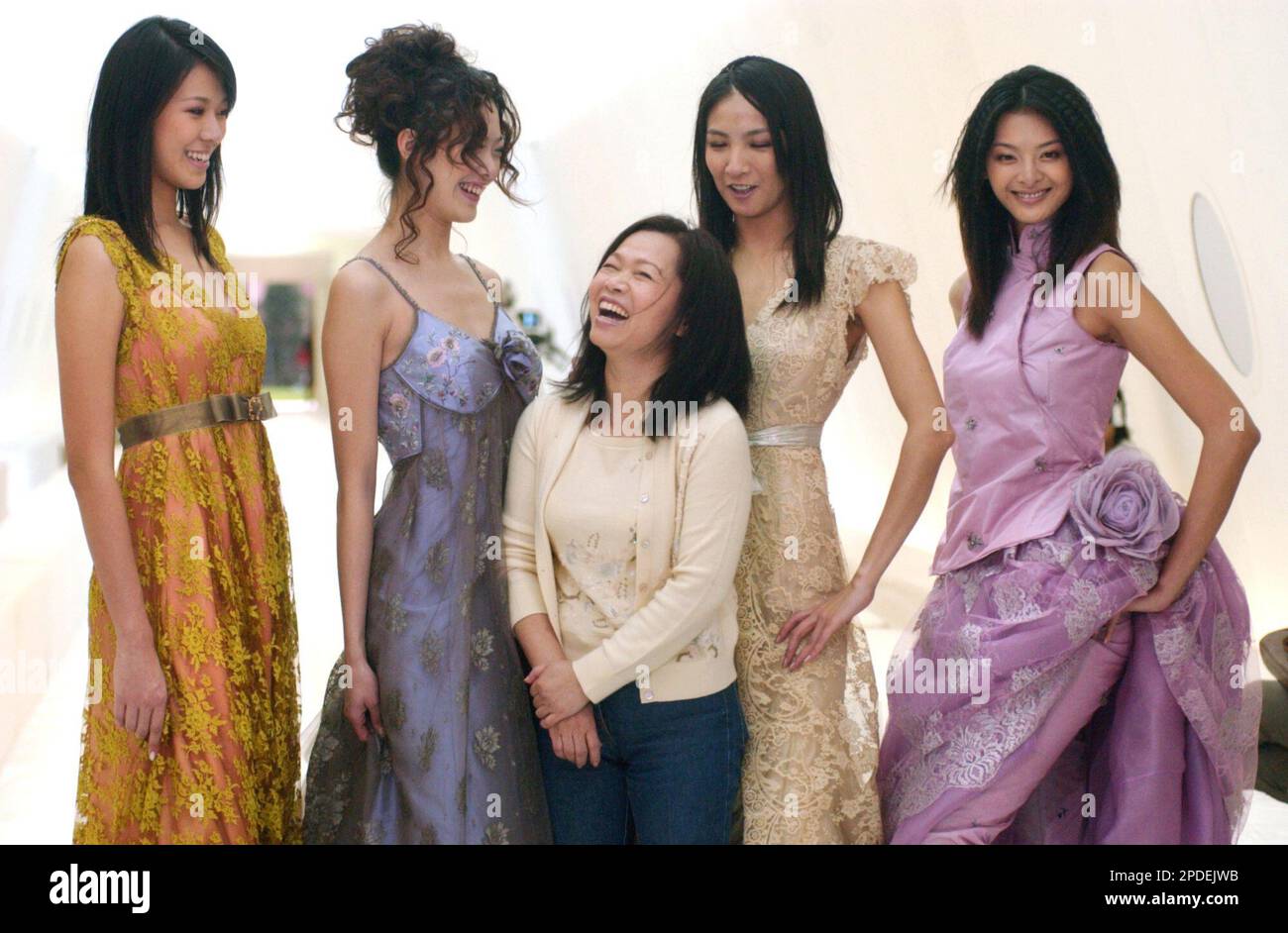 Taiwanese fashion designer Shiatzy Chen, center, laughs with her models ...