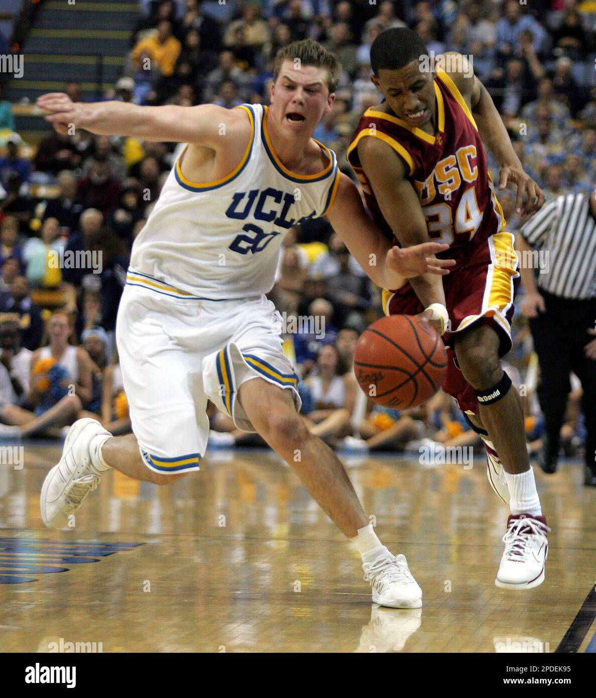 UCLA's Michael Roll, left, fouls Southern California's Gabe Pruitt ...