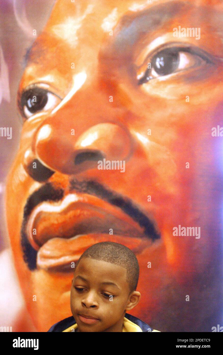 Marcus Davis, 12, stands in front of a Martin Luther King, Jr. poster ...