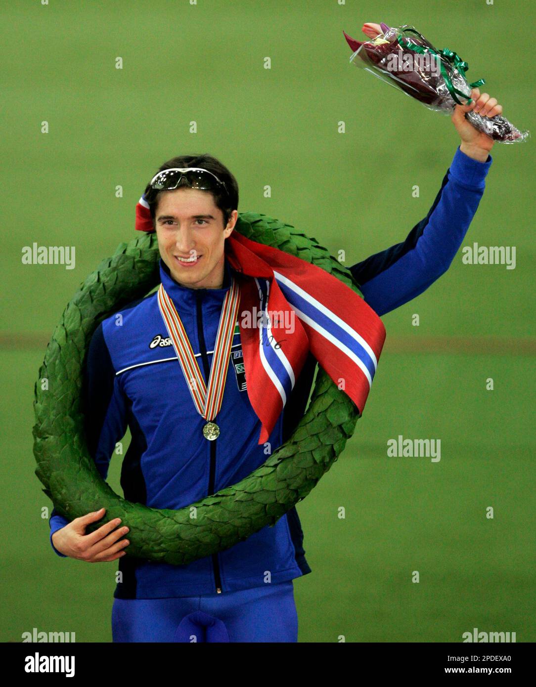 Italy's Enrico Fabris celebrates on the podium after winning the gold ...