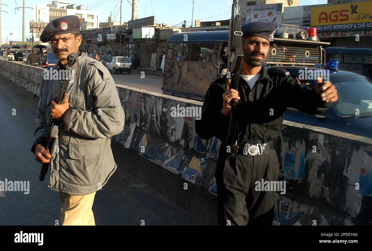 Pakistani police officers stand at the site of firing incident, Sunday ...