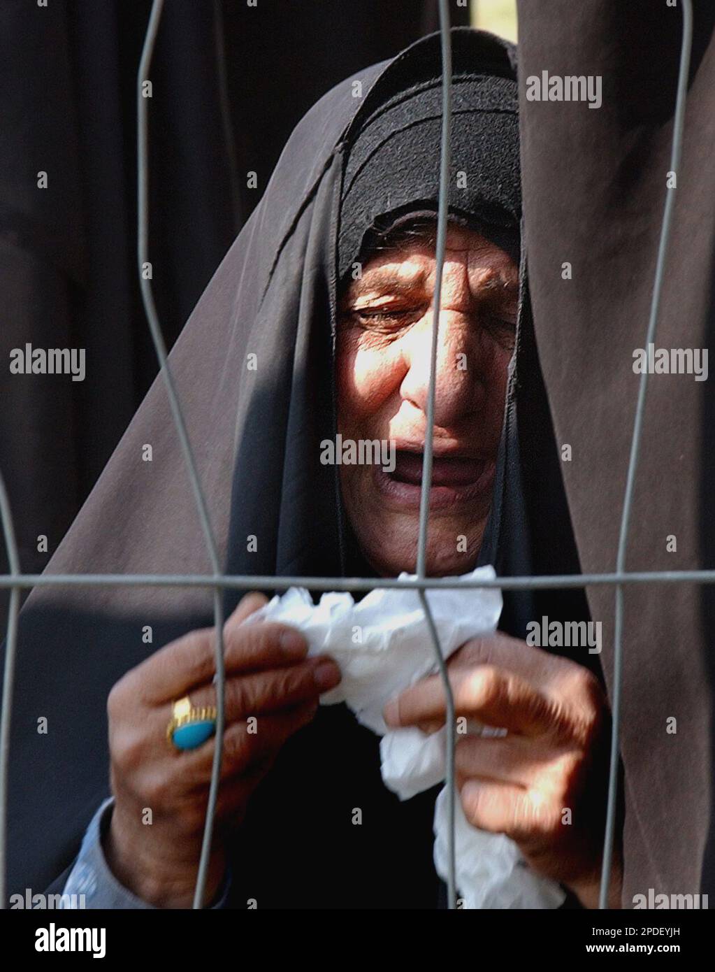 A Kuwaiti woman cries while waiting for the start of the funeral ...