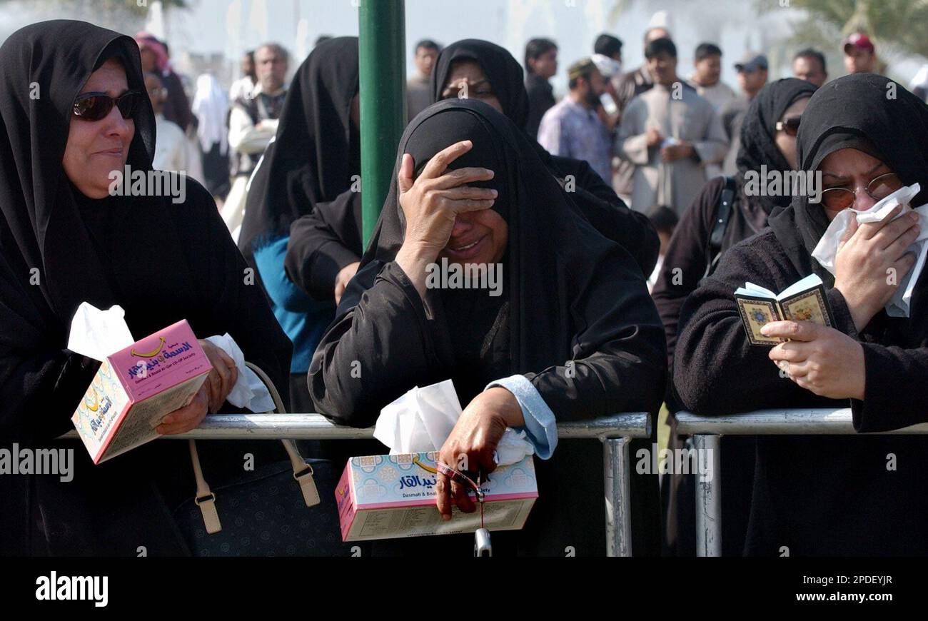 Kuwaiti women weep and read the Quran while waiting for the start of ...