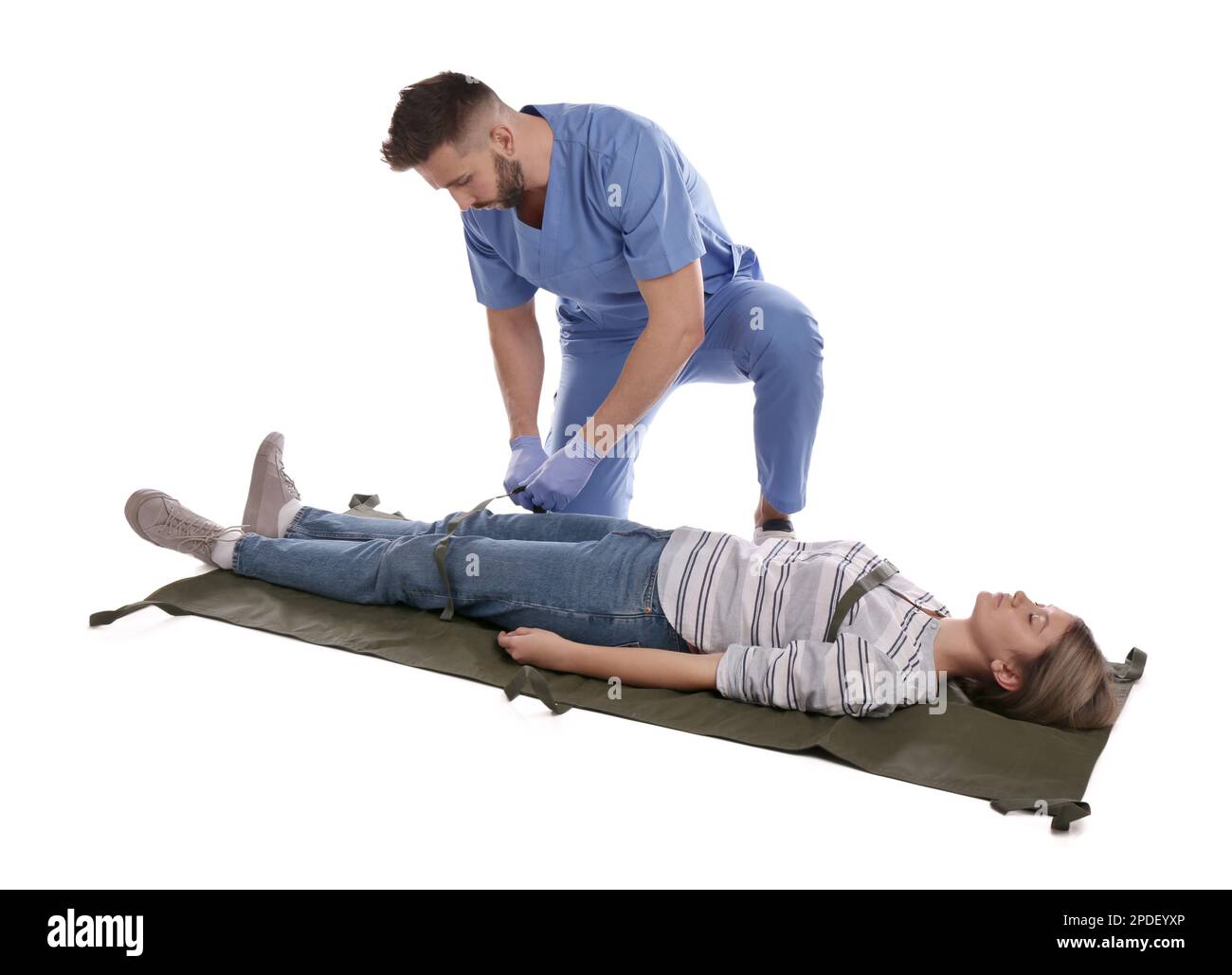 Doctor in uniform fixing woman on stretcher Stock Photo - Alamy