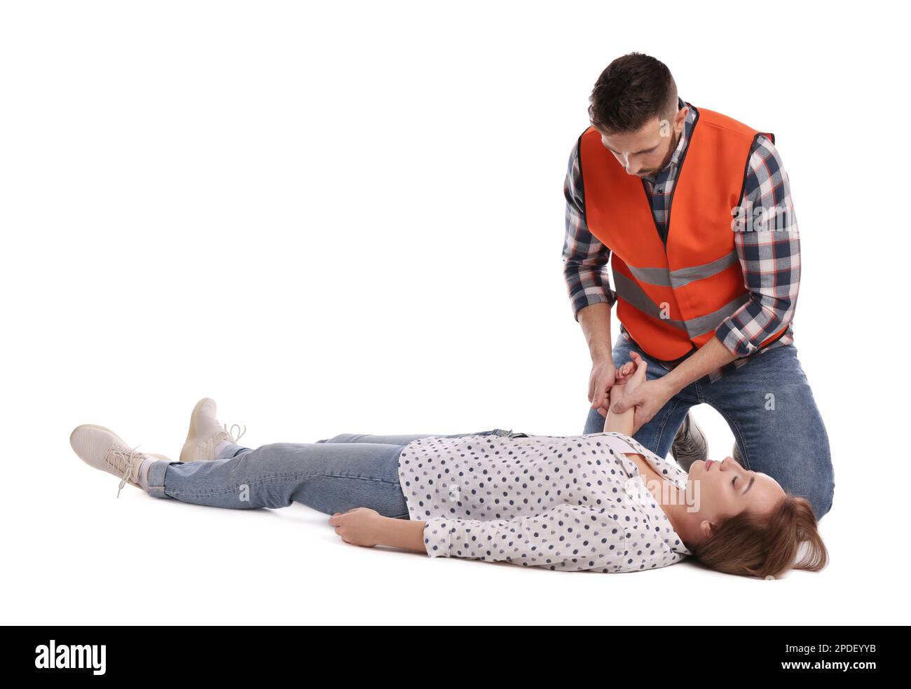 Paramedic in uniform performing first aid on unconscious woman against ...