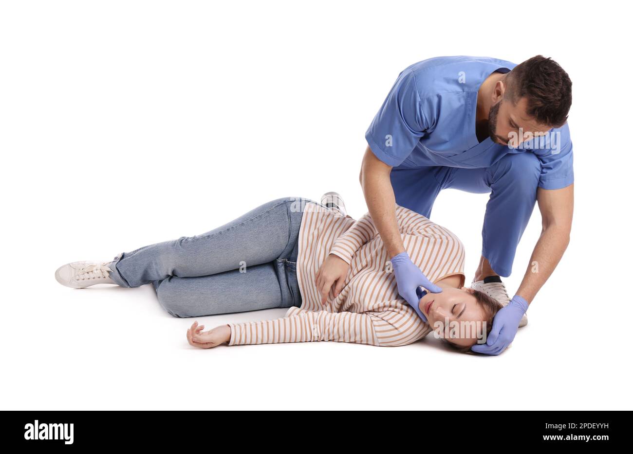 Doctor in uniform performing first aid on unconscious woman against ...