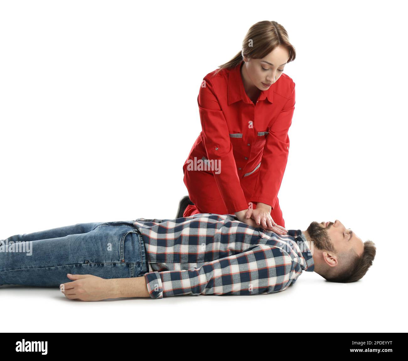 Paramedic in uniform performing first aid on unconscious man against ...