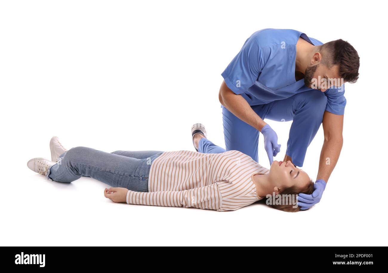 Doctor in uniform performing first aid on unconscious woman against ...